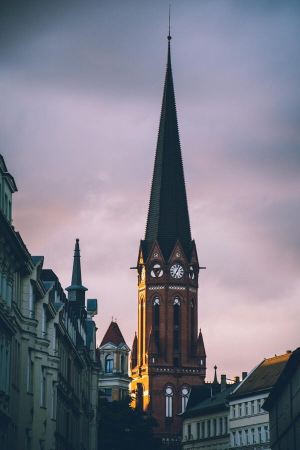 Gothic clock tower of a historic church in Leipzig on a cloudy day