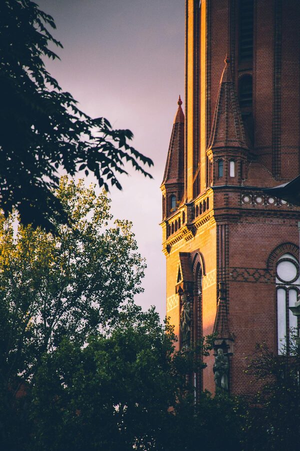 Historic red brick church in Leipzig at sunset with golden light