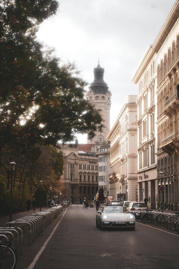 Leipzig street with historic architecture and a lamp post on a clear day