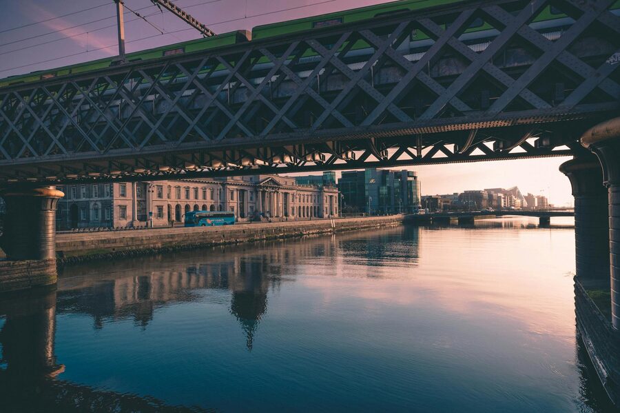 A Liffey bridge at sunset with warm light on the water