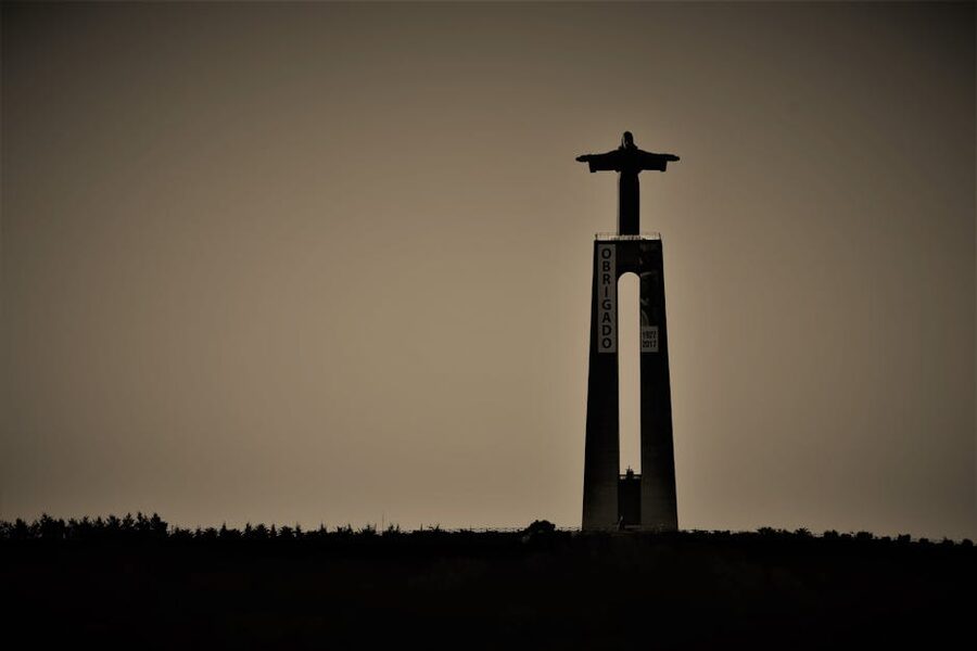 Silhouette of Cristo Rei statue Lisbon sunset