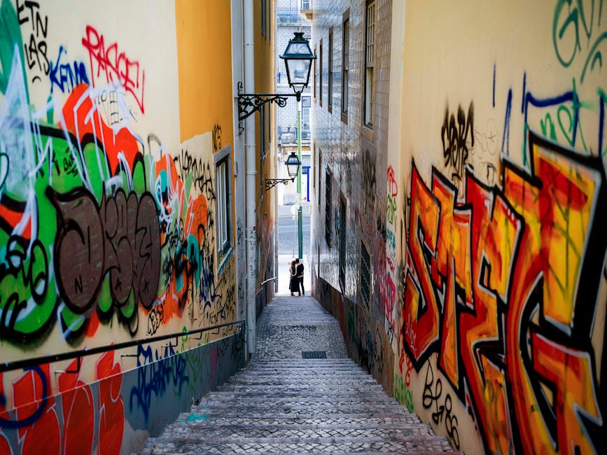 Graffiti-covered staircase alley in central Lisbon
