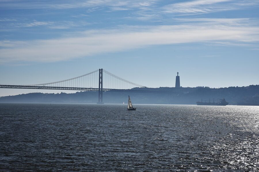 Sailboat on the Tagus River with 25 de Abril Bridge in the background