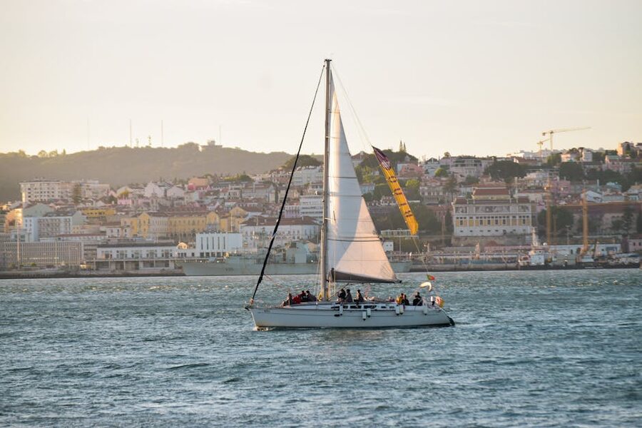 Sailboat cruising along the Lisbon waterfront