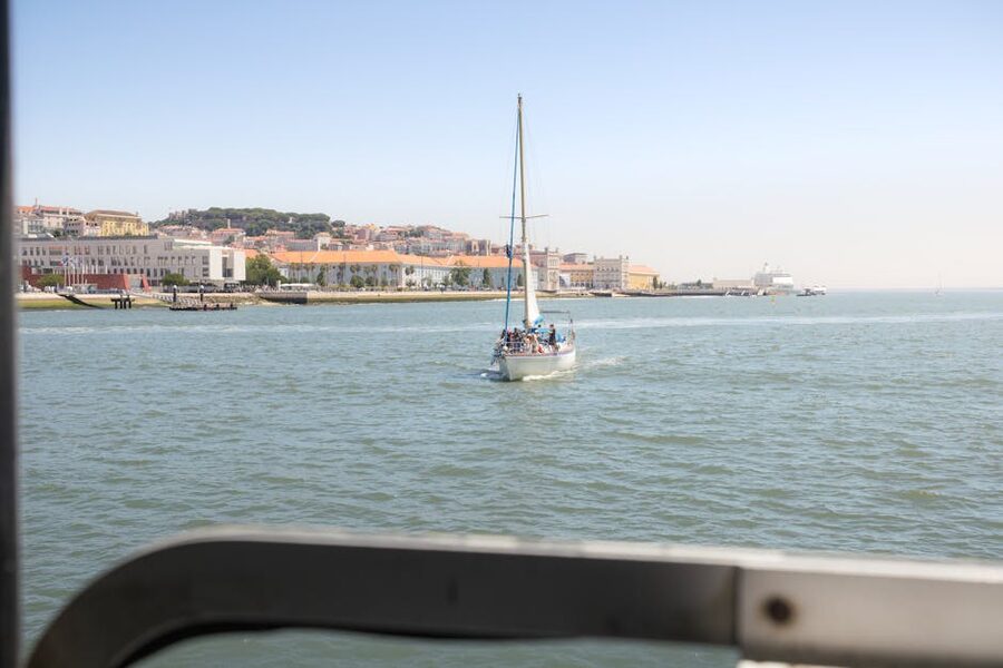 Sailboat with passengers navigating the Lisbon waterfront