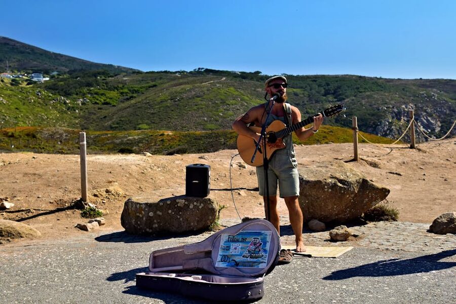Lisbon street musician playing guitar outdoors