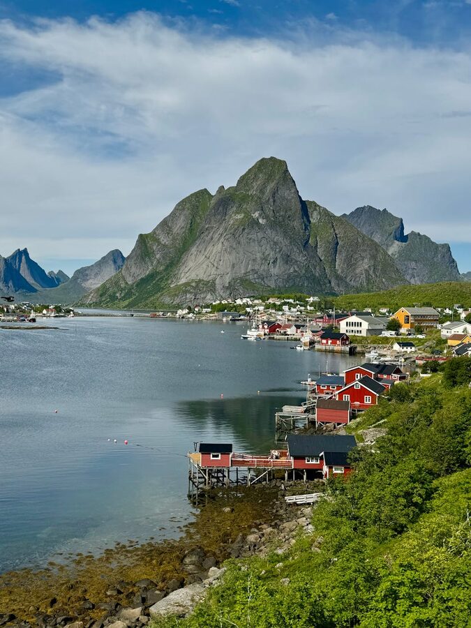 Norwegian fjord village with colourful houses and towering mountains