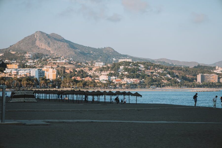 Malaga beach at sunset with umbrellas