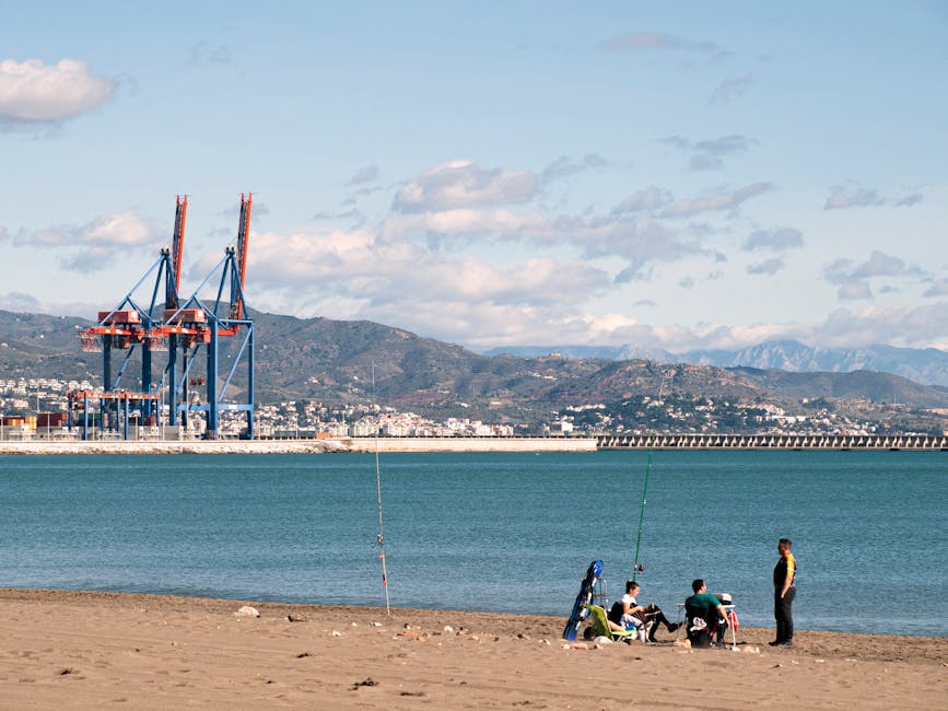 Malaga beach with harbour and mountains