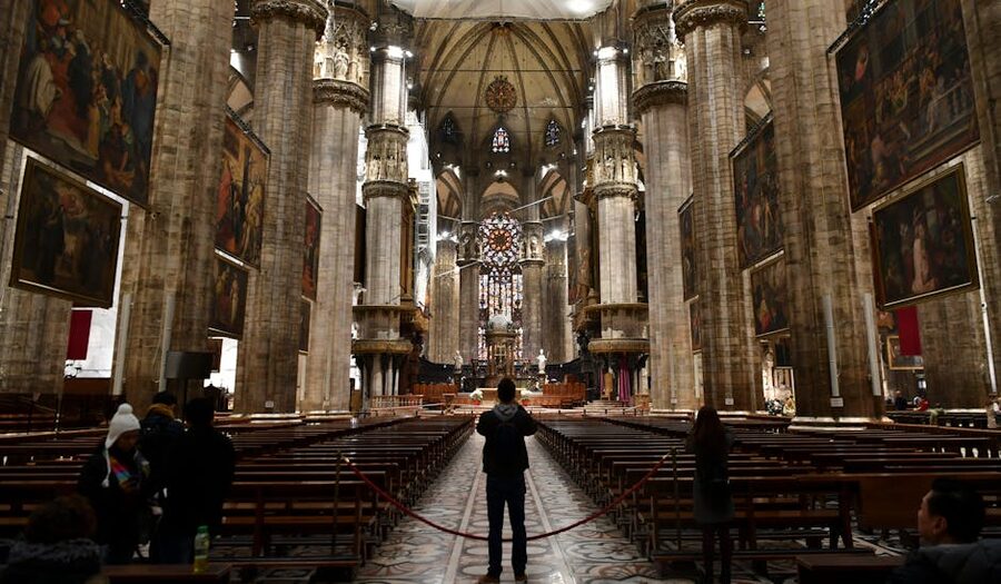 Milan Cathedral interior with towering Gothic arches and stained glass