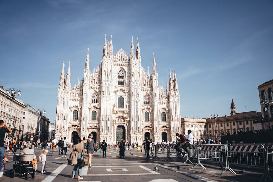 Milan Duomo Piazza with people walking in front of cathedral