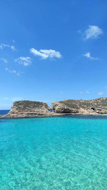Clear turquoise sea and rocky limestone cliffs at Malta's Blue Lagoon