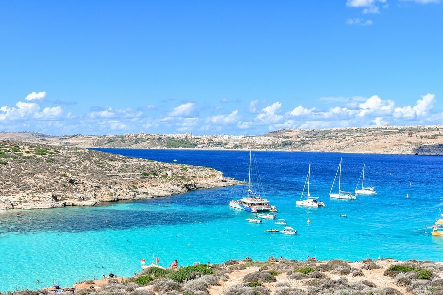 Comino island with turquoise lagoon waters and rocky Mediterranean coastline