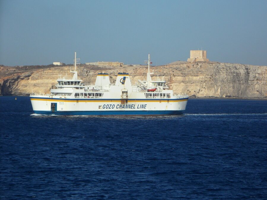 Car ferry crossing between Malta and Gozo with passengers and vehicles