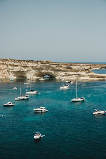 Aerial view of Mġarr harbour in Gozo with boats and the red-domed church above