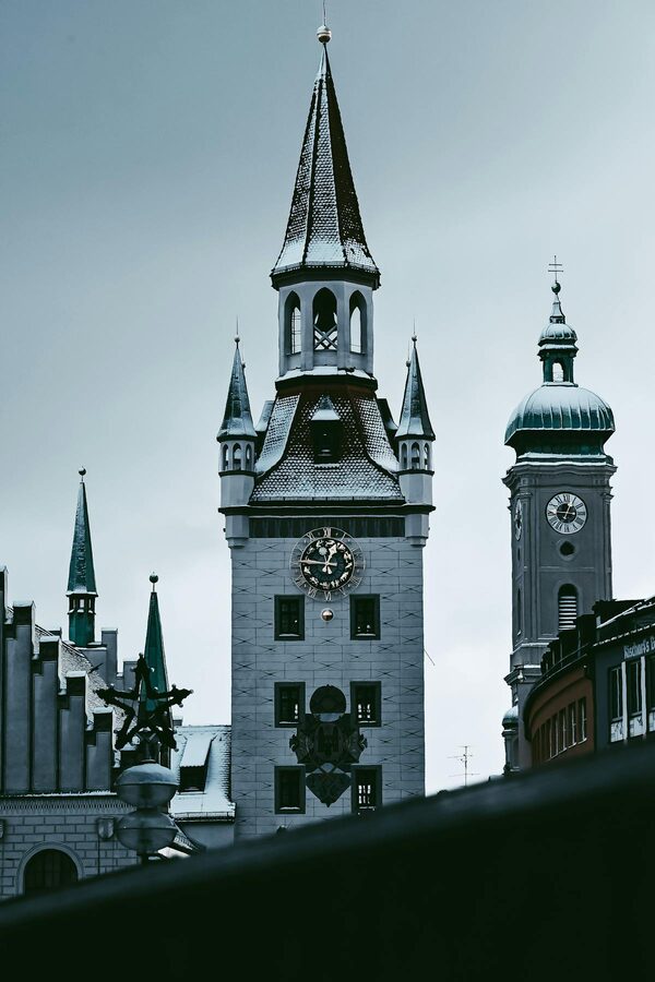 Historic clock tower on a Munich building against blue sky
