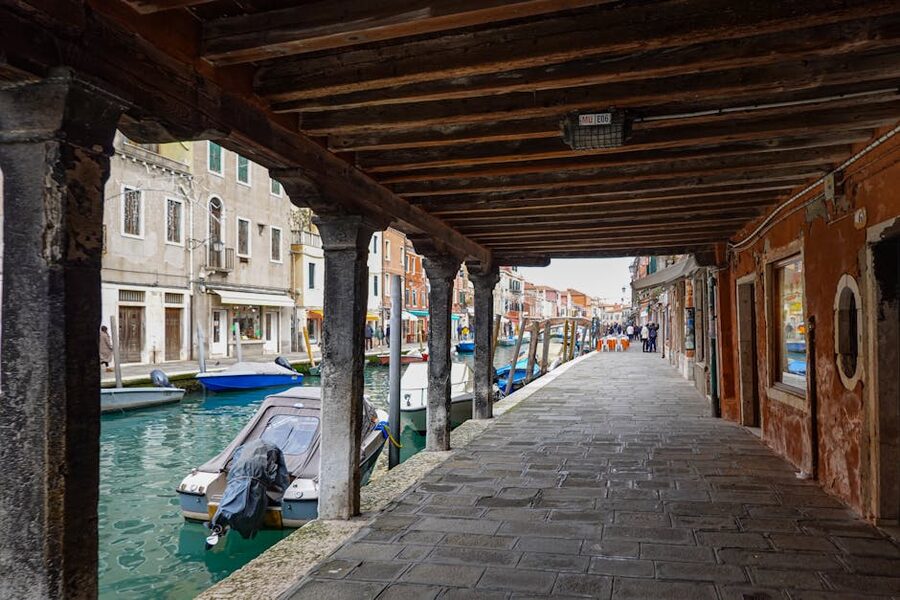 Canal in Murano Italy with rustic buildings and boats