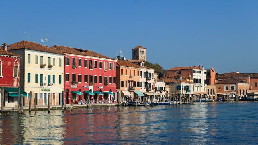 Brightly coloured houses lining canal in Murano Venice