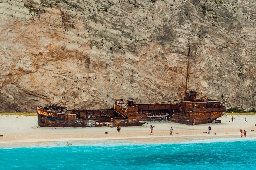 Sunken ship rests on Navagio Beach surrounded by cliffs, Zakynthos