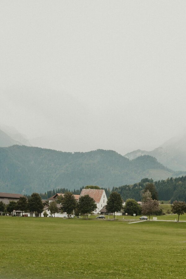 Bavarian village in Germany with mountain backdrop and greenery