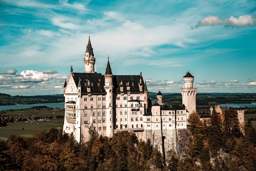 Aerial view of Neuschwanstein Castle in Bavaria against bright blue sky