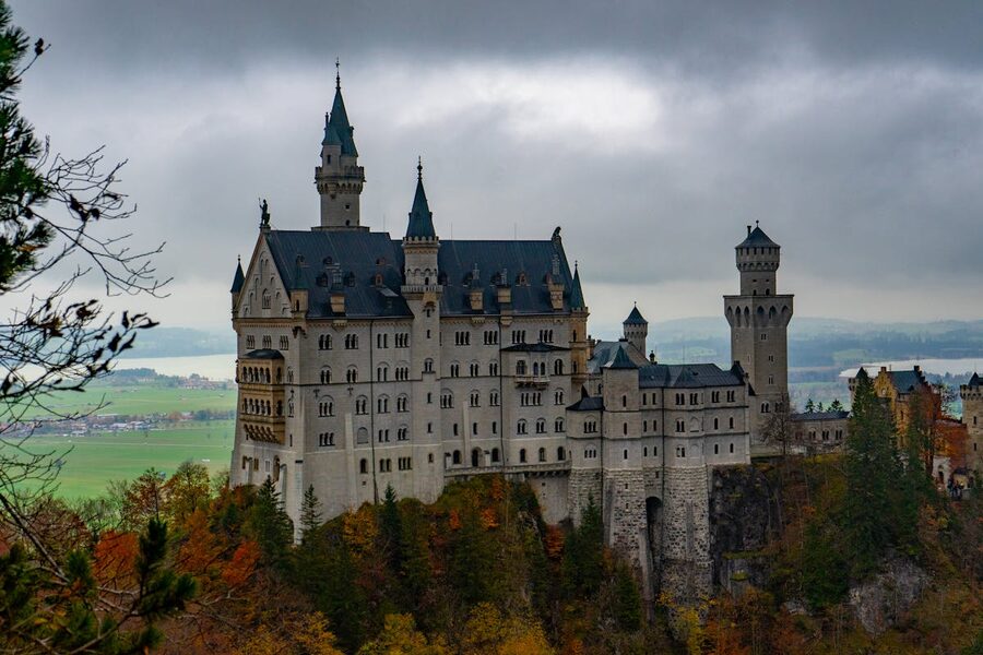 Neuschwanstein Castle amidst colorful autumn foliage in Bavaria Germany
