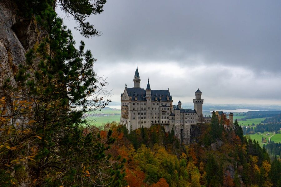 Neuschwanstein Castle surrounded by autumn foliage in Bavaria
