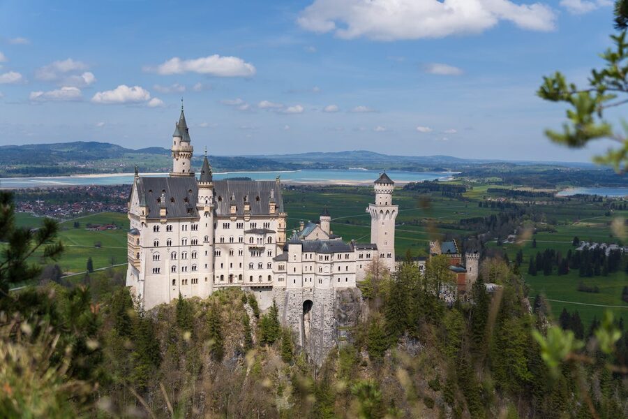 Neuschwanstein Castle surrounded by green hills in Bavaria