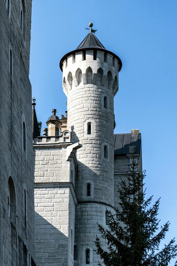 Close-up of Neuschwanstein Castle tower against blue sky in Bavaria