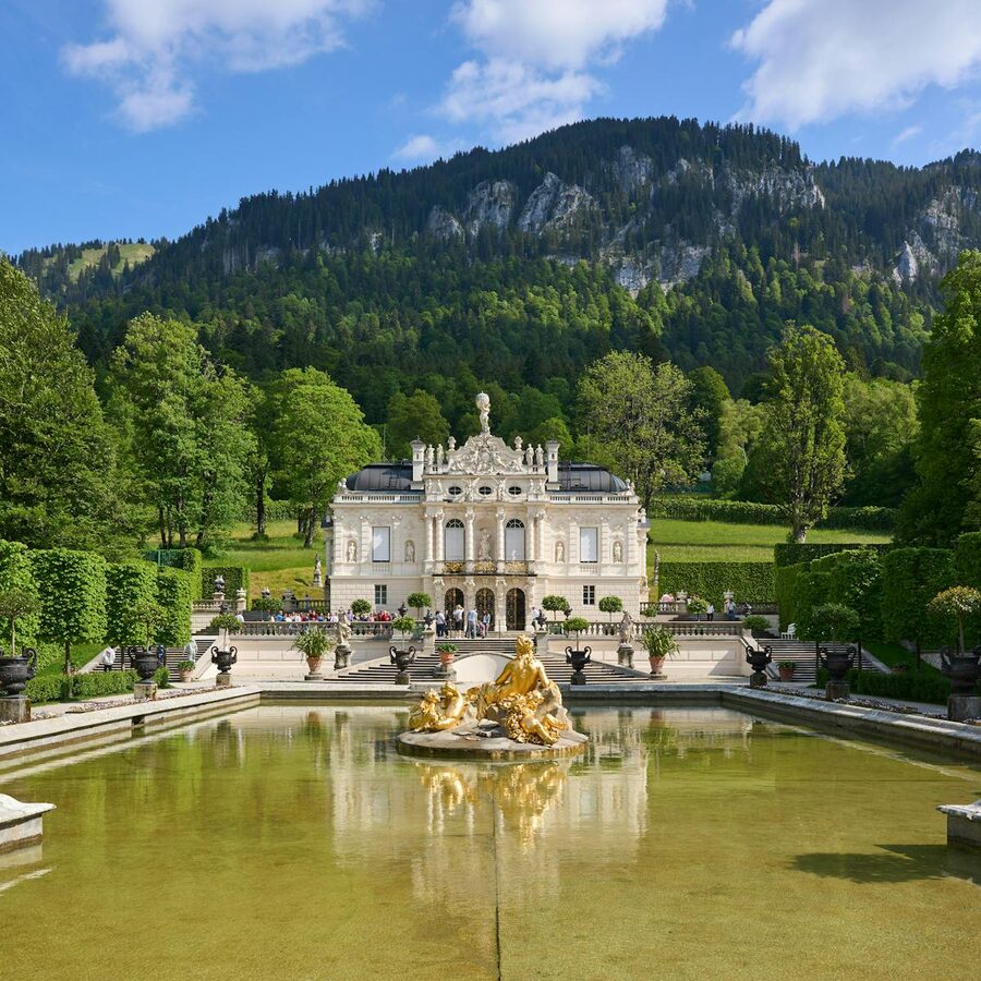 Linderhof Palace with gardens and scenic mountain backdrop in Bavaria