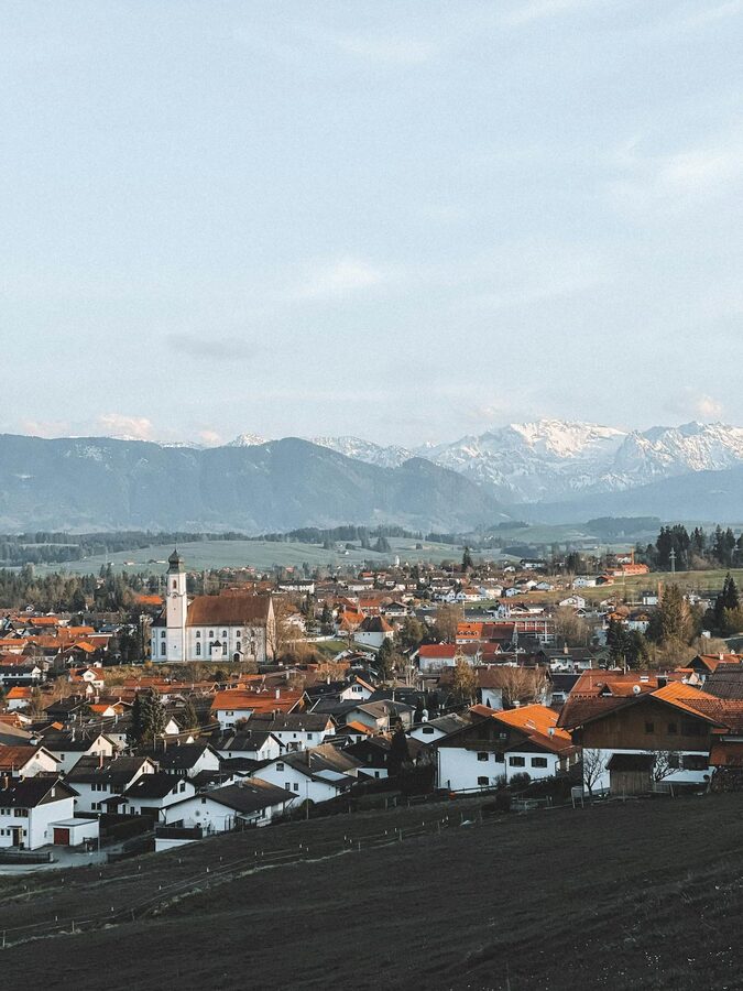 Schwangau town with Bavarian Alps in the background and church