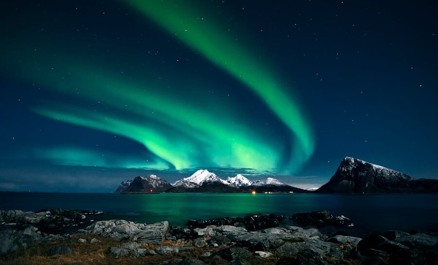 Aurora borealis curtain of light over Nordic landscape