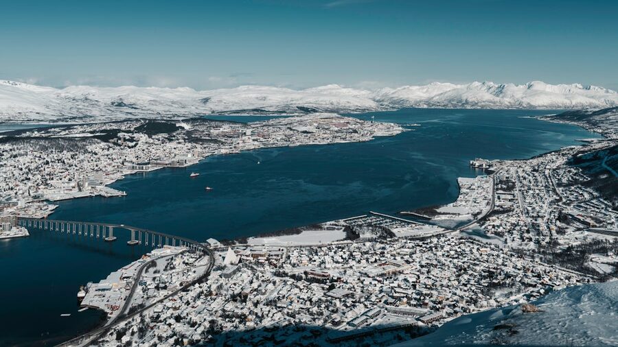 Snow-covered Arctic mountains above a Norwegian town