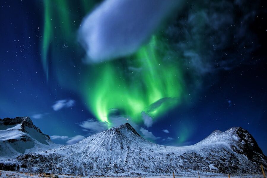 Green aurora borealis bands stretching across the sky