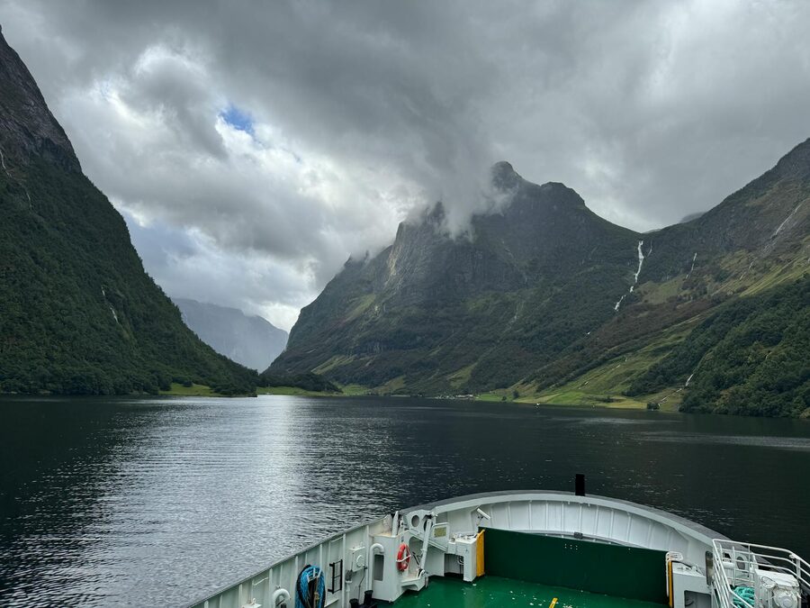 View from a boat of Norwegian fjord with steep mountains on both sides