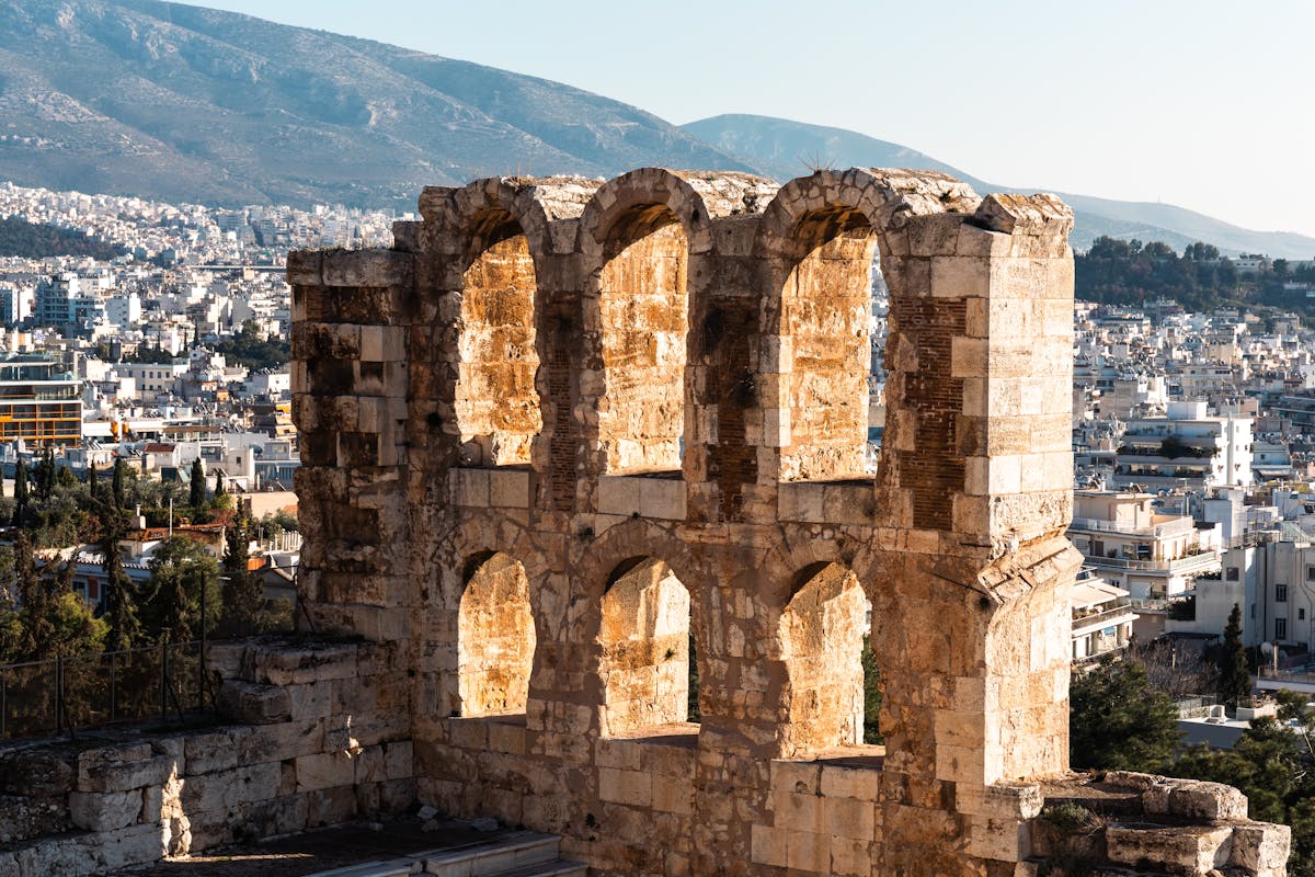 Ancient Odeon of Herodes Atticus theatre in Athens with city backdrop