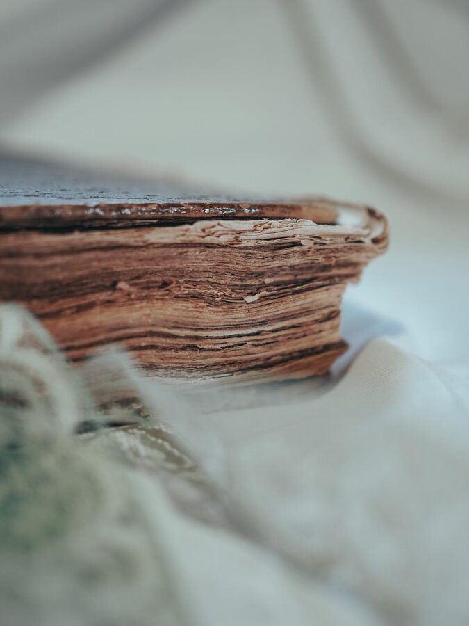 Close-up of an antique book showing aged and textured pages
