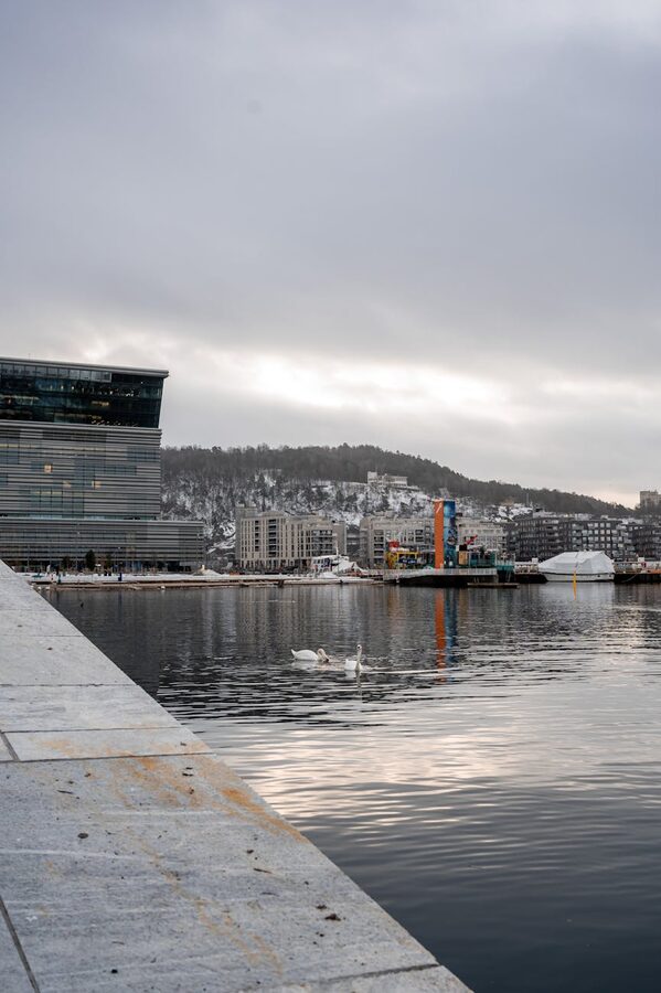 Oslo harbour in winter with modern architecture reflecting on water