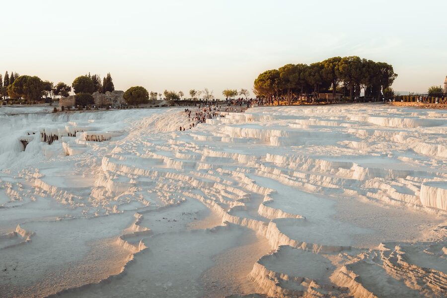 Pamukkale travertine terraces at sunset with warm golden light