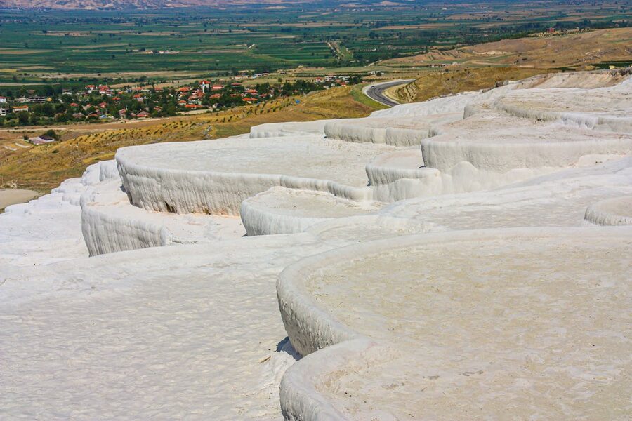 High angle view of white travertine terraces and thermal pools at Pamukkale