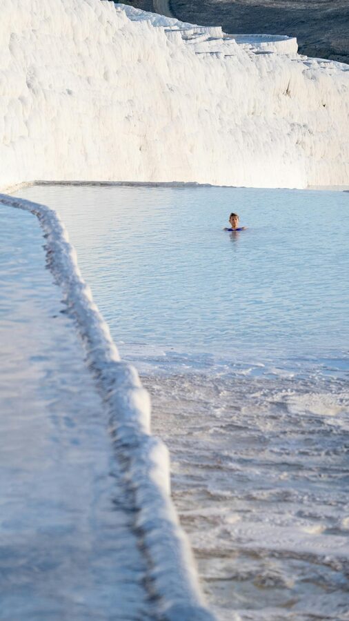 Person swimming in warm thermal waters at Pamukkale Turkey