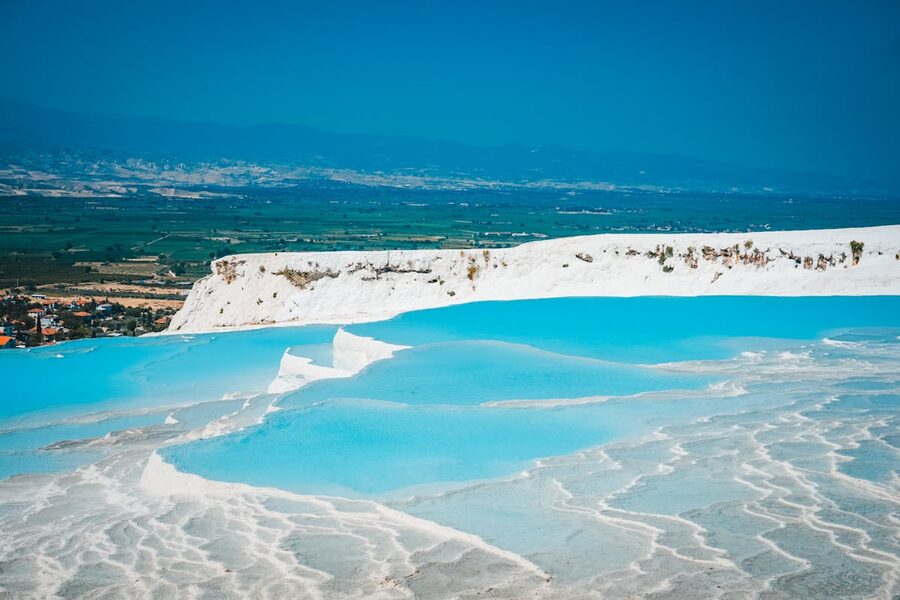 Turquoise mineral pools on white travertine terraces at Pamukkale