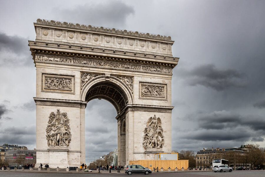The Arc de Triomphe on a cloudy day with dramatic sky