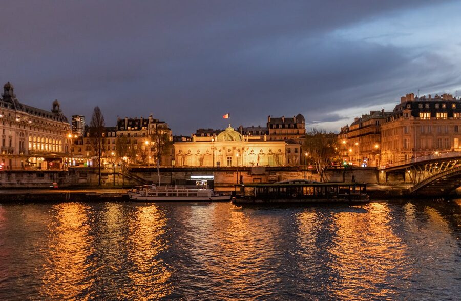Illuminated Parisian bridges and landmarks reflected in the Seine at night