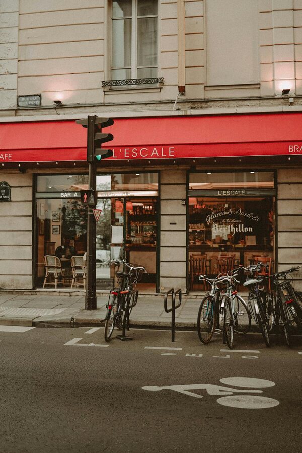 Parisian café with bicycles parked outside on a lively city street