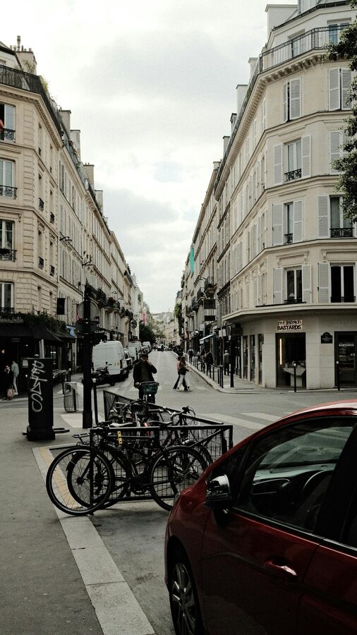 Paris street scene with bicycles, classic architecture, and people strolling