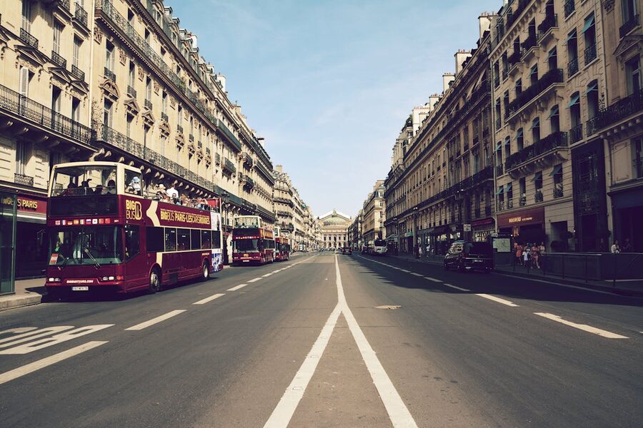 Sightseeing buses on a Paris boulevard near the Opéra Garnier
