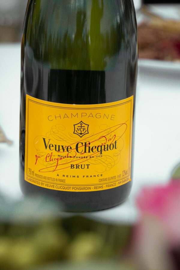 Close-up of a Veuve Clicquot champagne bottle showing the iconic yellow label