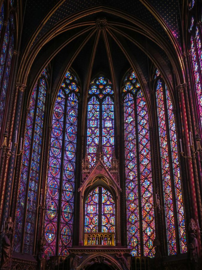 Stained glass windows glowing blue in Sainte-Chapelle