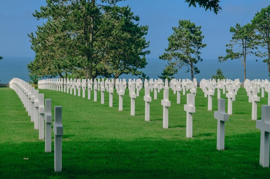 Wide view of the Normandy American Cemetery with rows of white crosses and green lawn